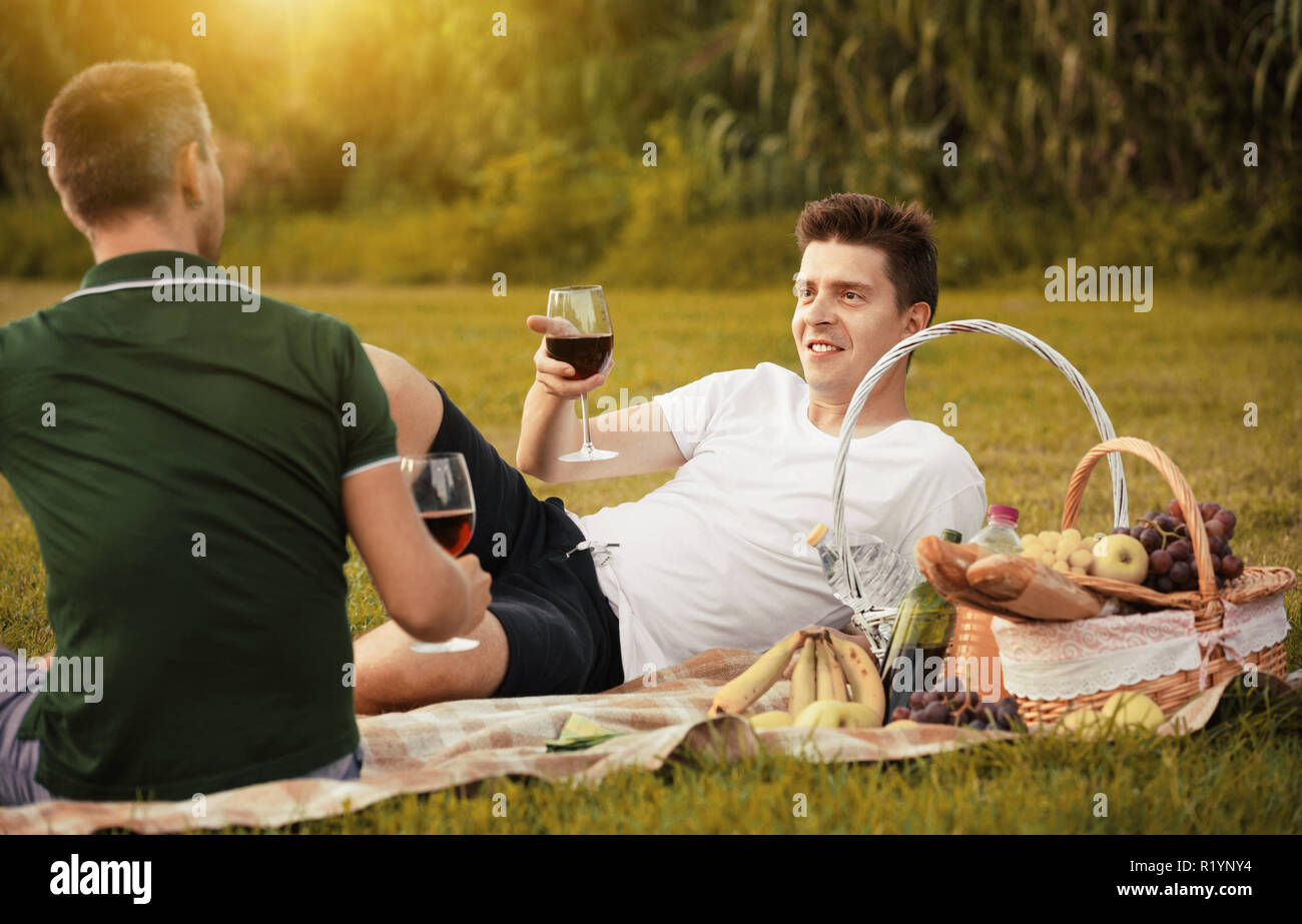 Happy cheerful positive smiling man enjoying life on picnic outdoors ...
