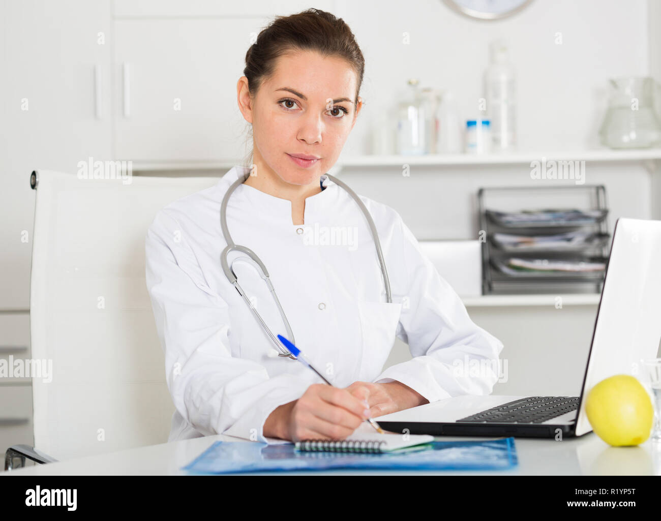 Female doctor having a productive day helping in her office Stock Photo ...