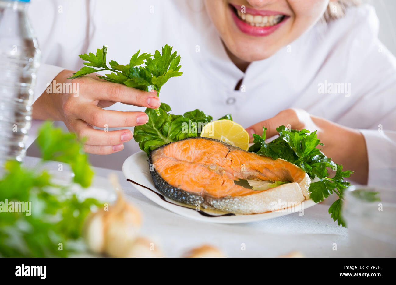 Professional chef with fried salmon fillet in commercial kitchen Stock ...