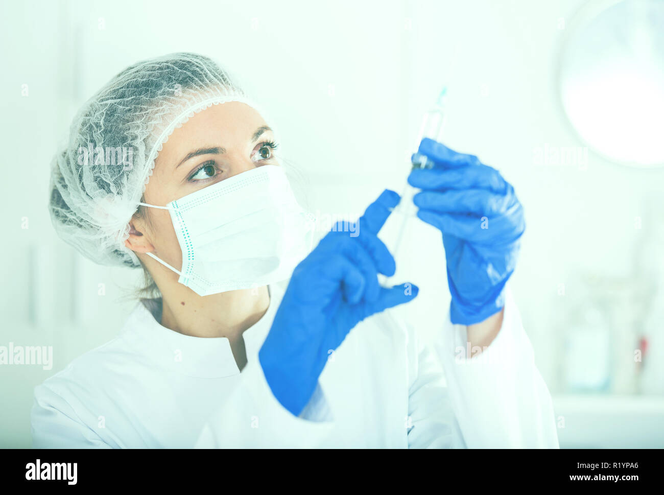 Female nurse holding syringe for injection in hospital Stock Photo - Alamy