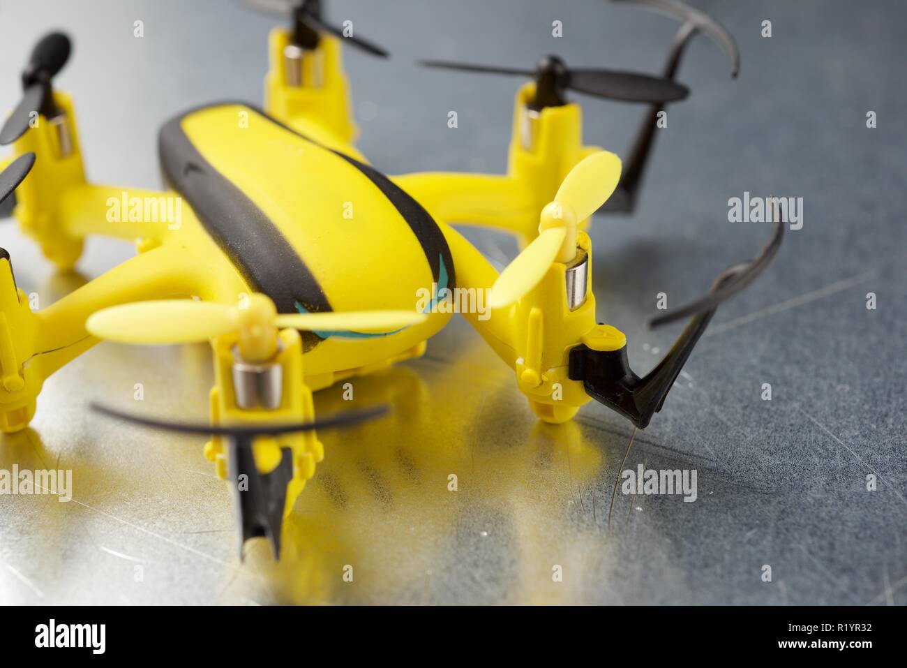 Yellow drone on a metal table Stock Photo - Alamy