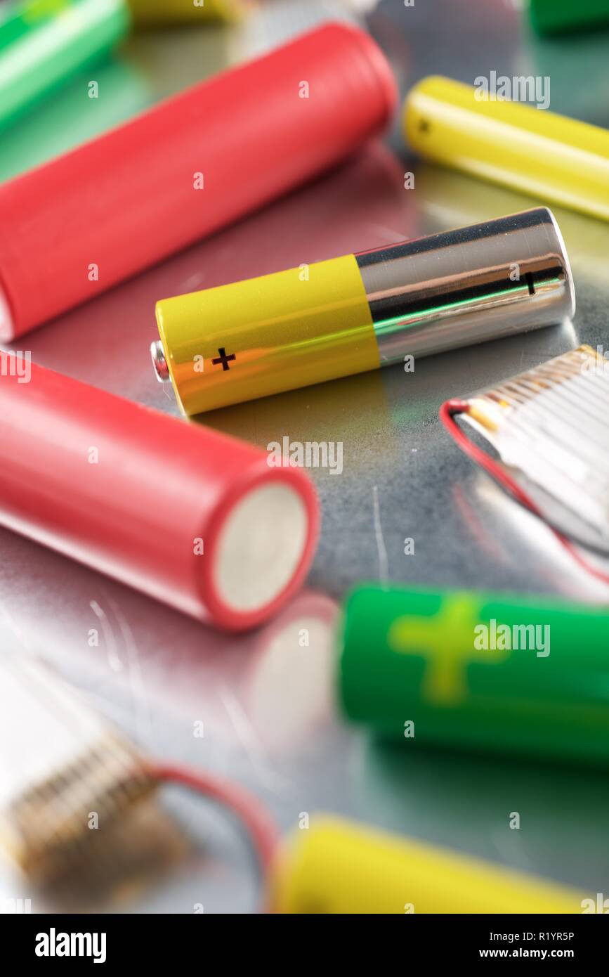 Many batteries on a metal table Stock Photo - Alamy