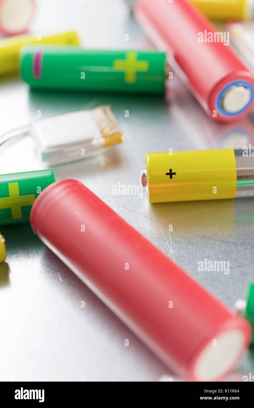 Many batteries on a metal table Stock Photo - Alamy