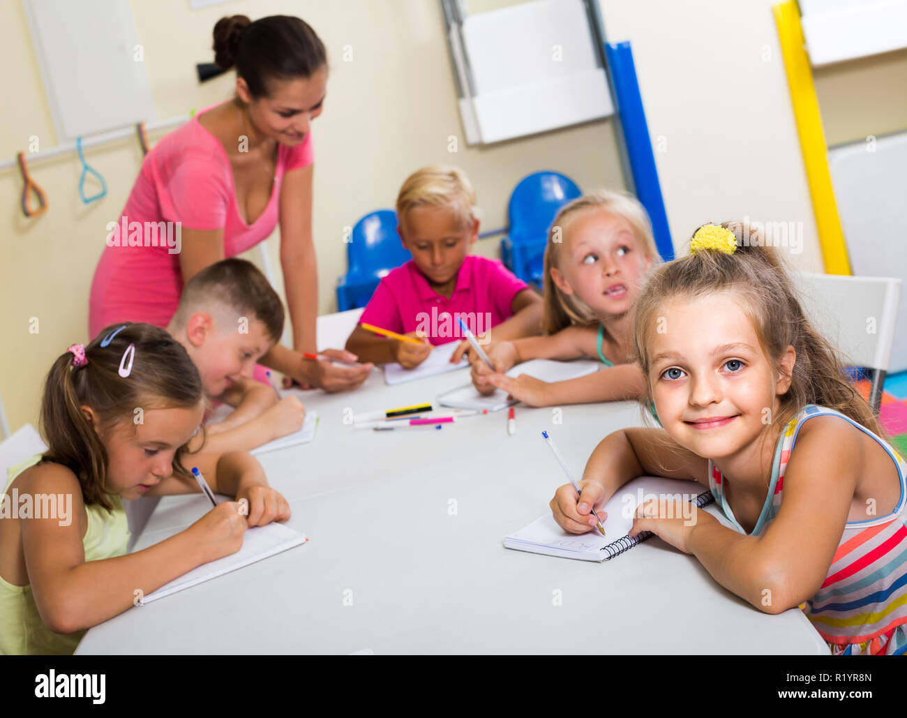 Smiling children making writing hi-res stock photography and images - Alamy