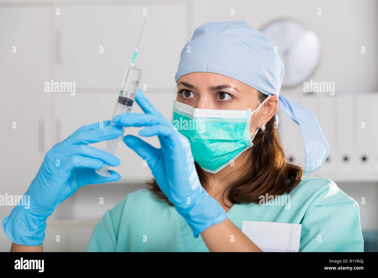 Professional nurse young woman making injection in modern hospital ...