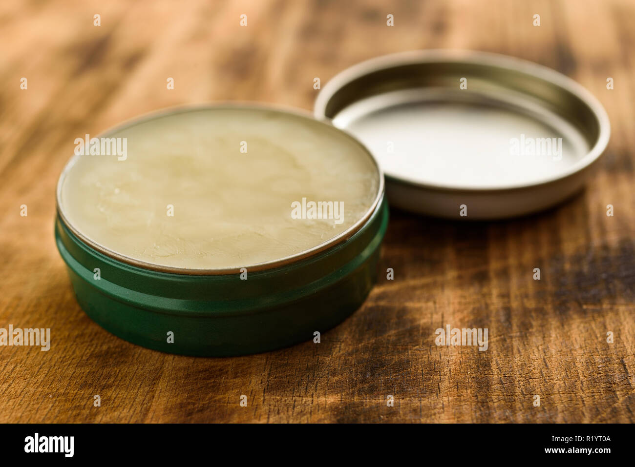 Organic balm in open small metal can, lid to the side Stock Photo - Alamy