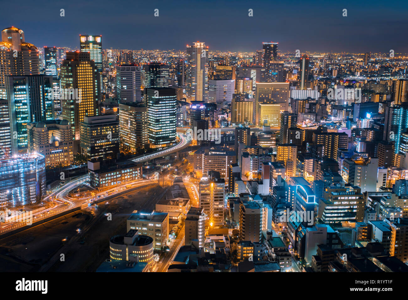 night cityscape of osaka urban skyscraper from top of umeda building ...