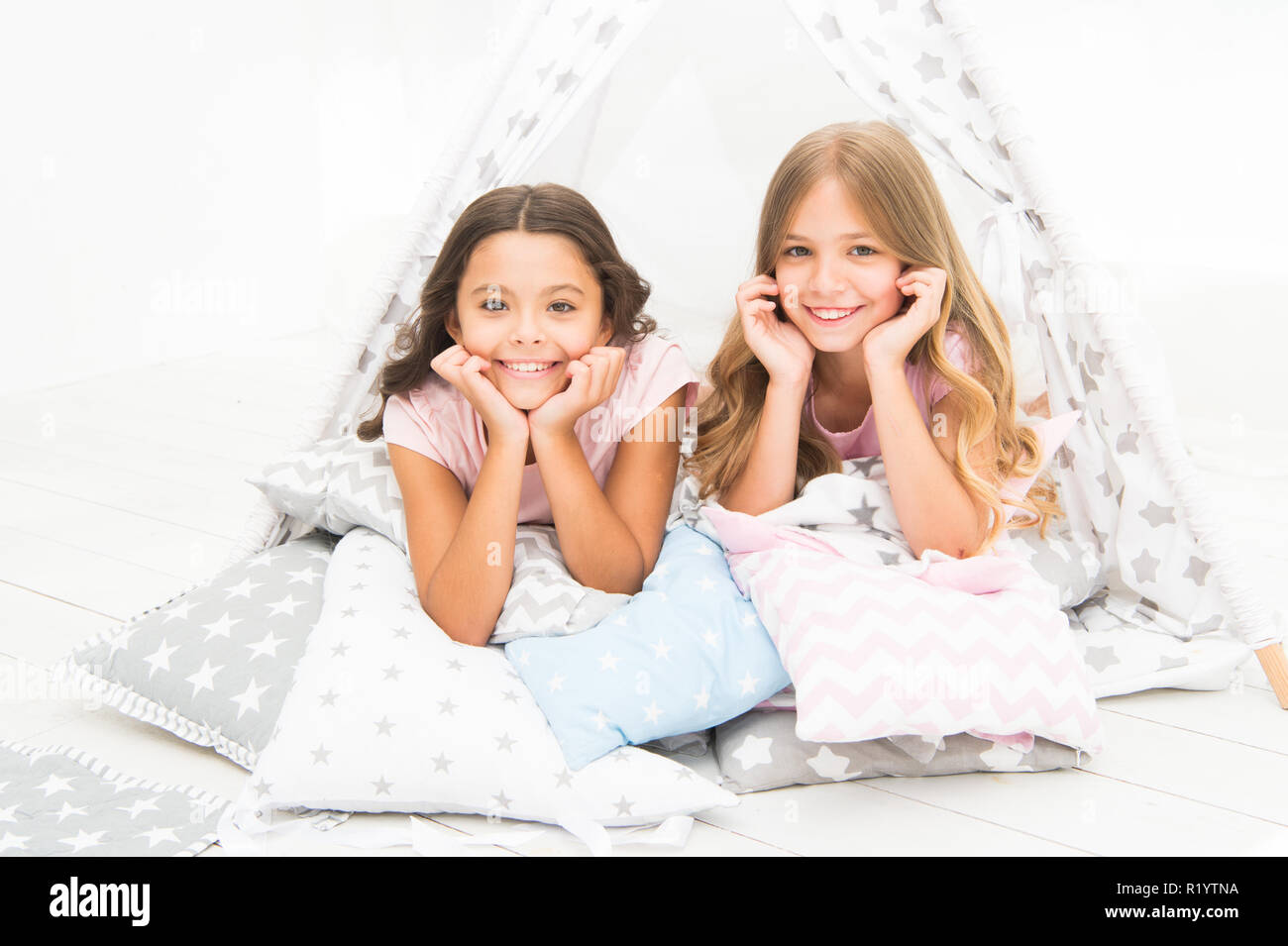 Girls having fun tipi house. Girlish leisure. Sisters share gossips ...