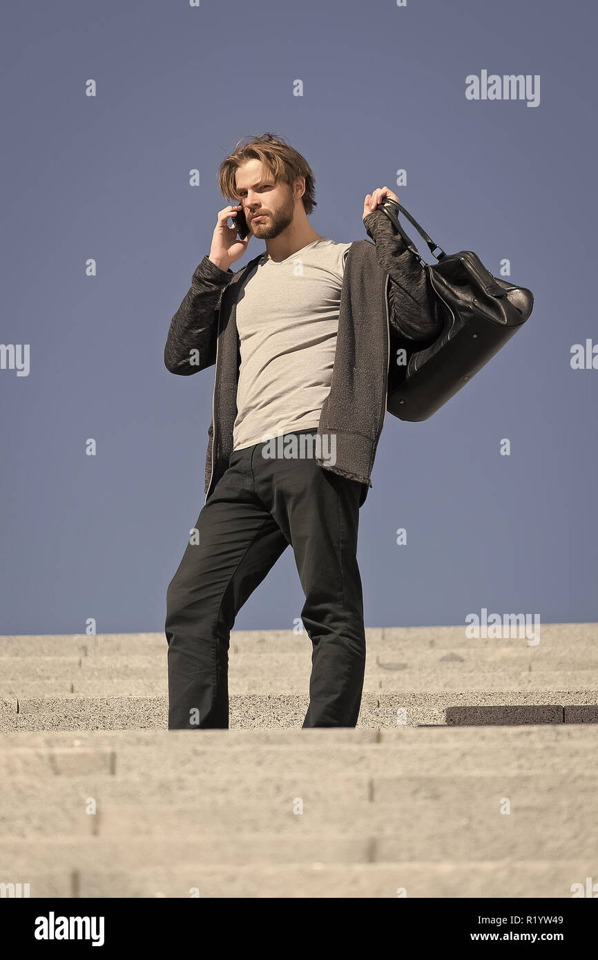 guy on stairs with phone, thoughtful young man sitting on a flight of ...