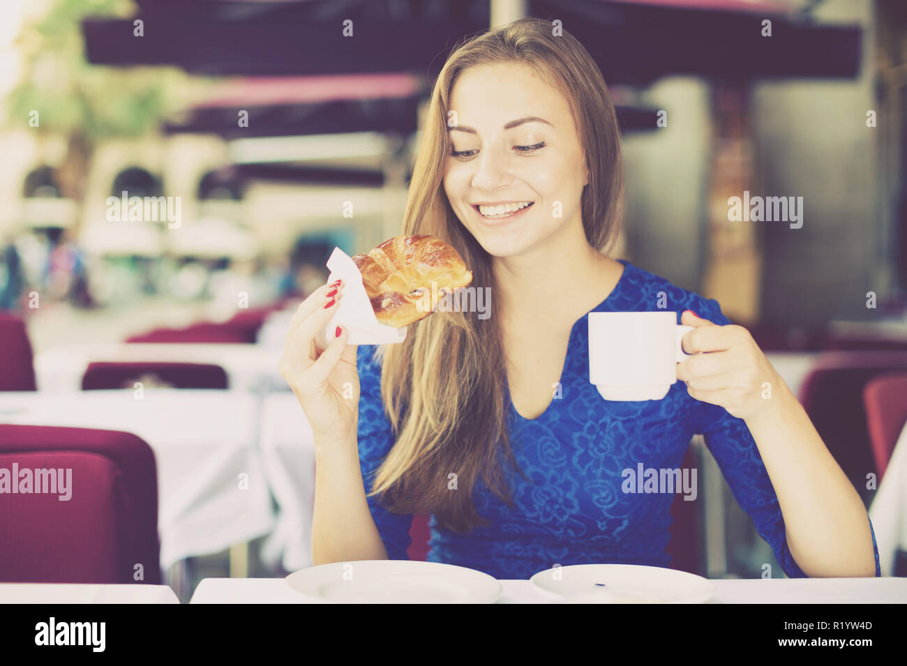 Cheerful female is enjoying of lunch in cafe Stock Photo - Alamy