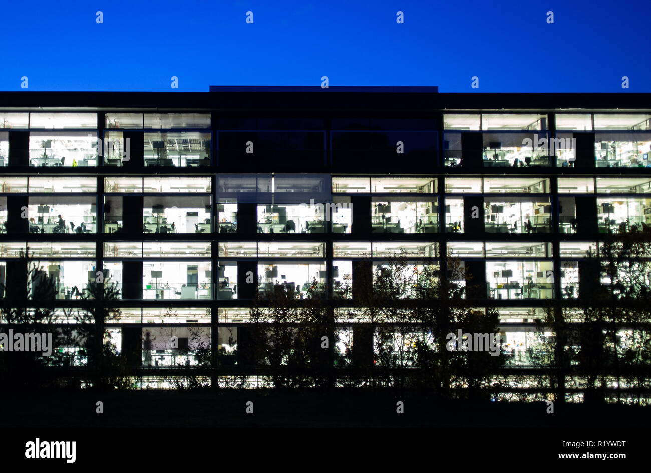Modern architecture office building illuminated at night outdoors blue ...