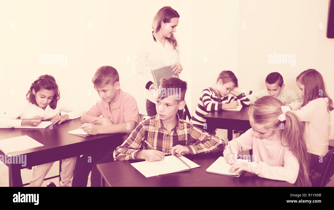 Little children learning with teacher in classroom Stock Photo - Alamy