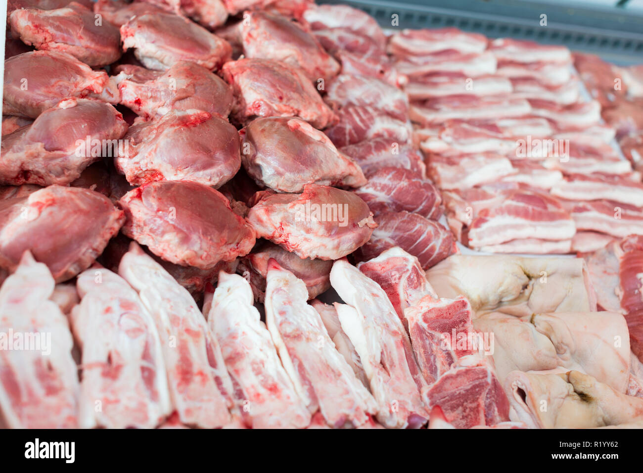 Variety of fresh raw meat on display in butcher shop Stock Photo - Alamy