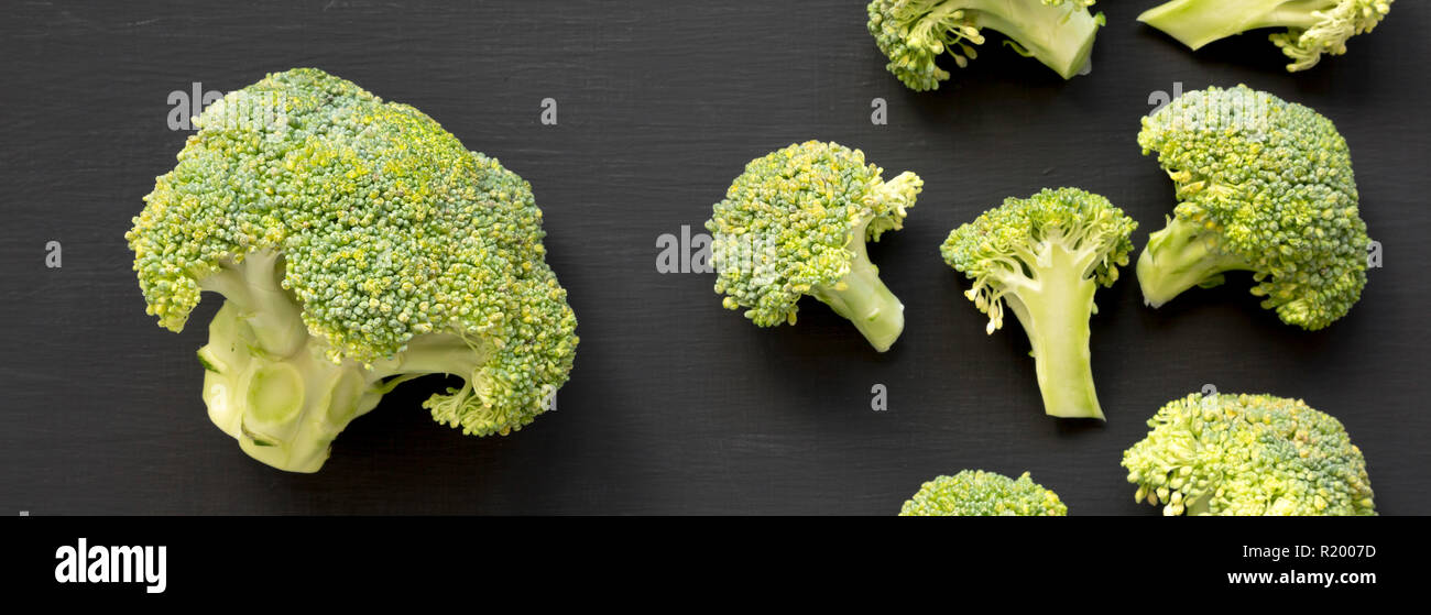 Raw broccoli on black background, top view. From above, flat lay ...