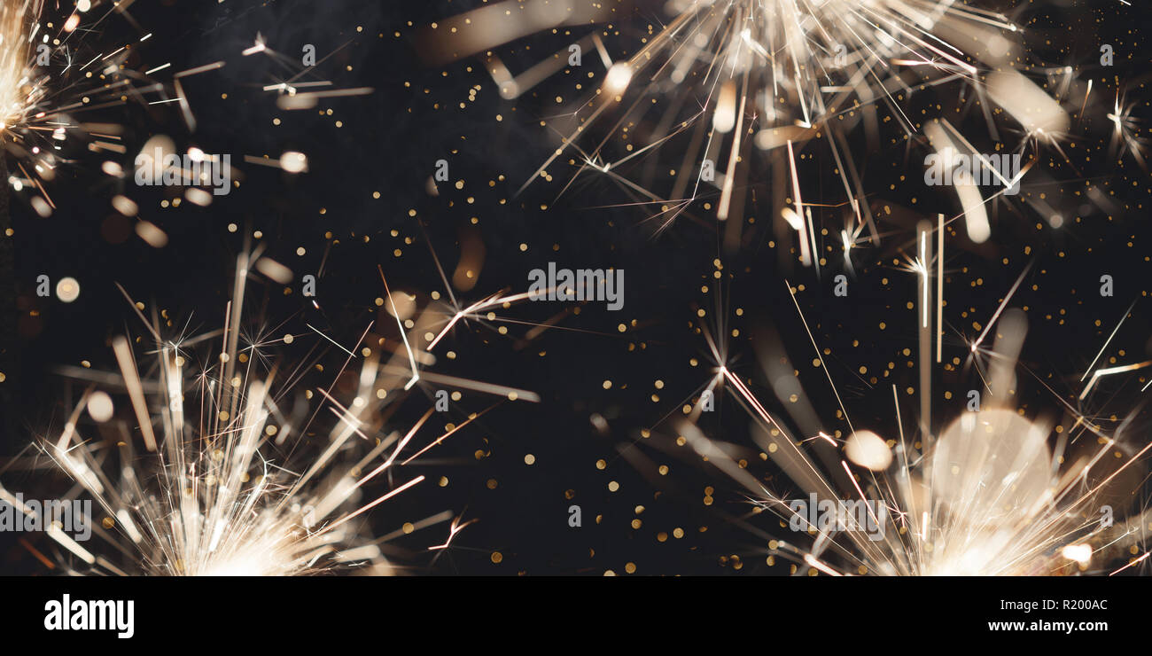 Burning christmas sparklers and smoke on dark background Stock Photo ...