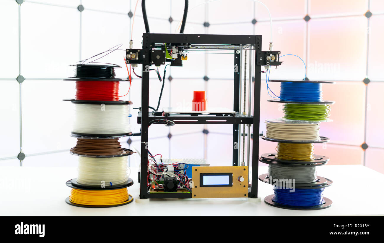 3d printer and plastic filament on color background Stock Photo - Alamy