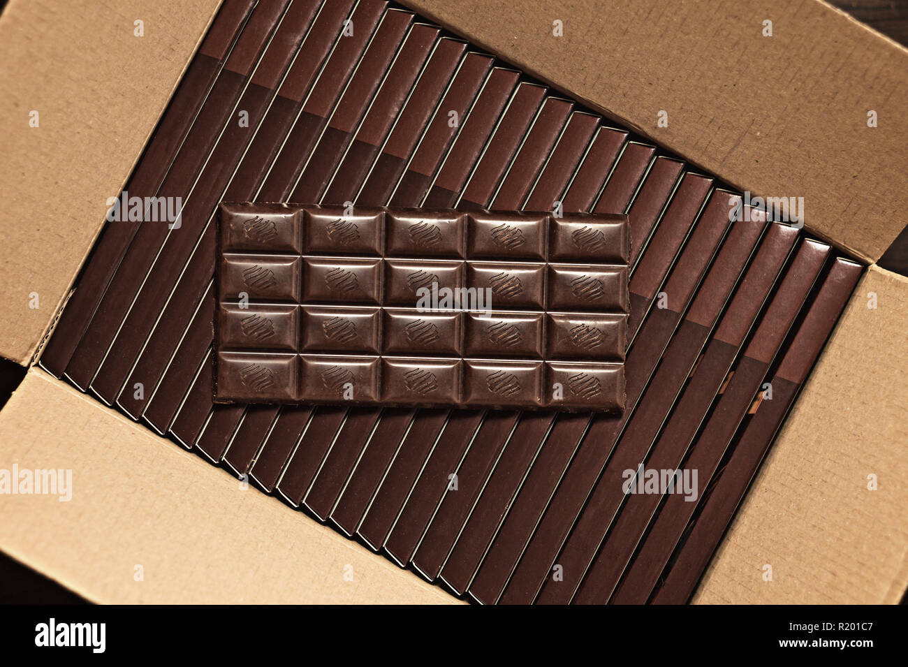 Tiles of dark chocolate on a cardboard box packed with chocolate. Top ...