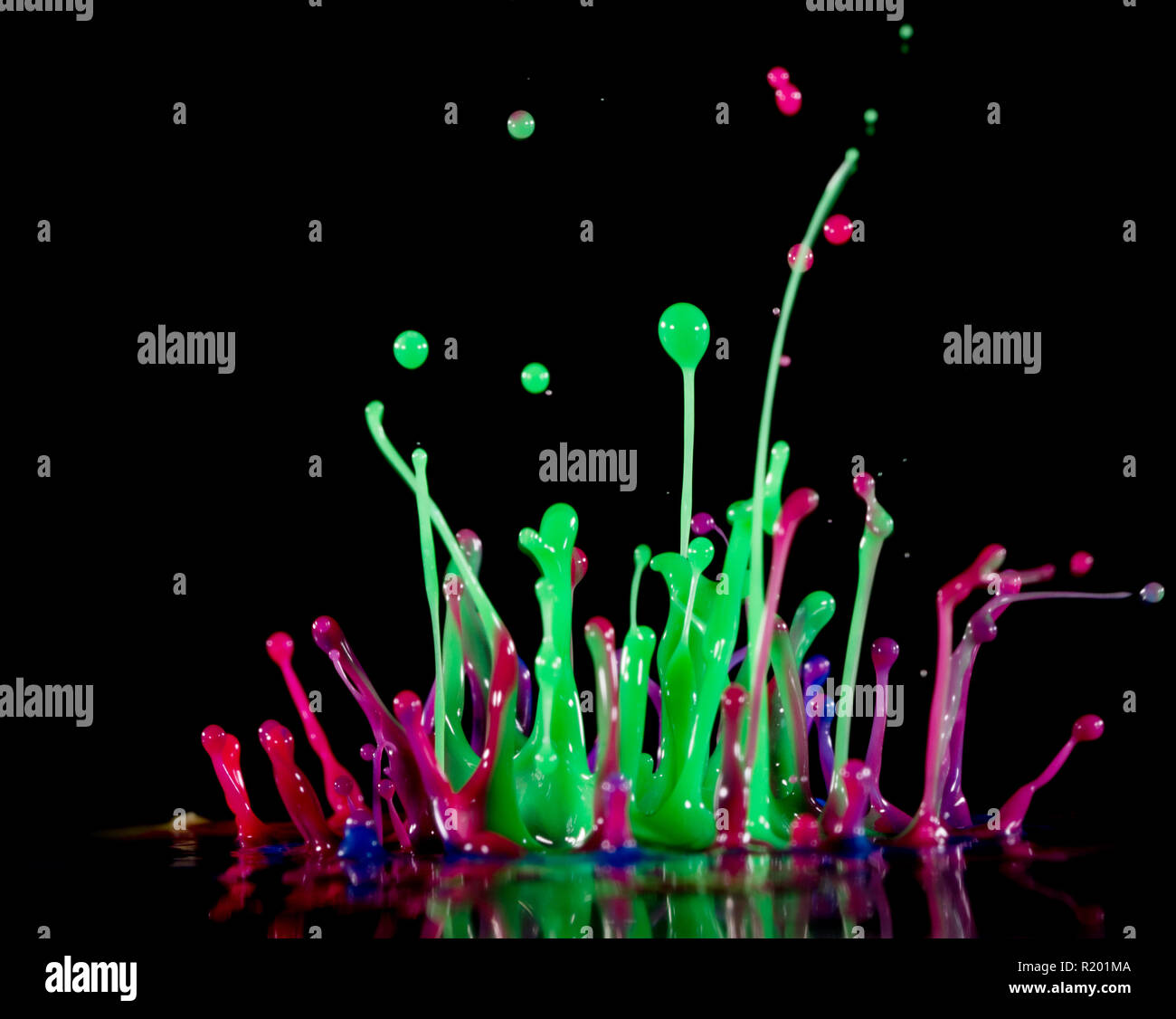 Abstract sculptures of colorful splashes of paint. Dancing liquid on a ...