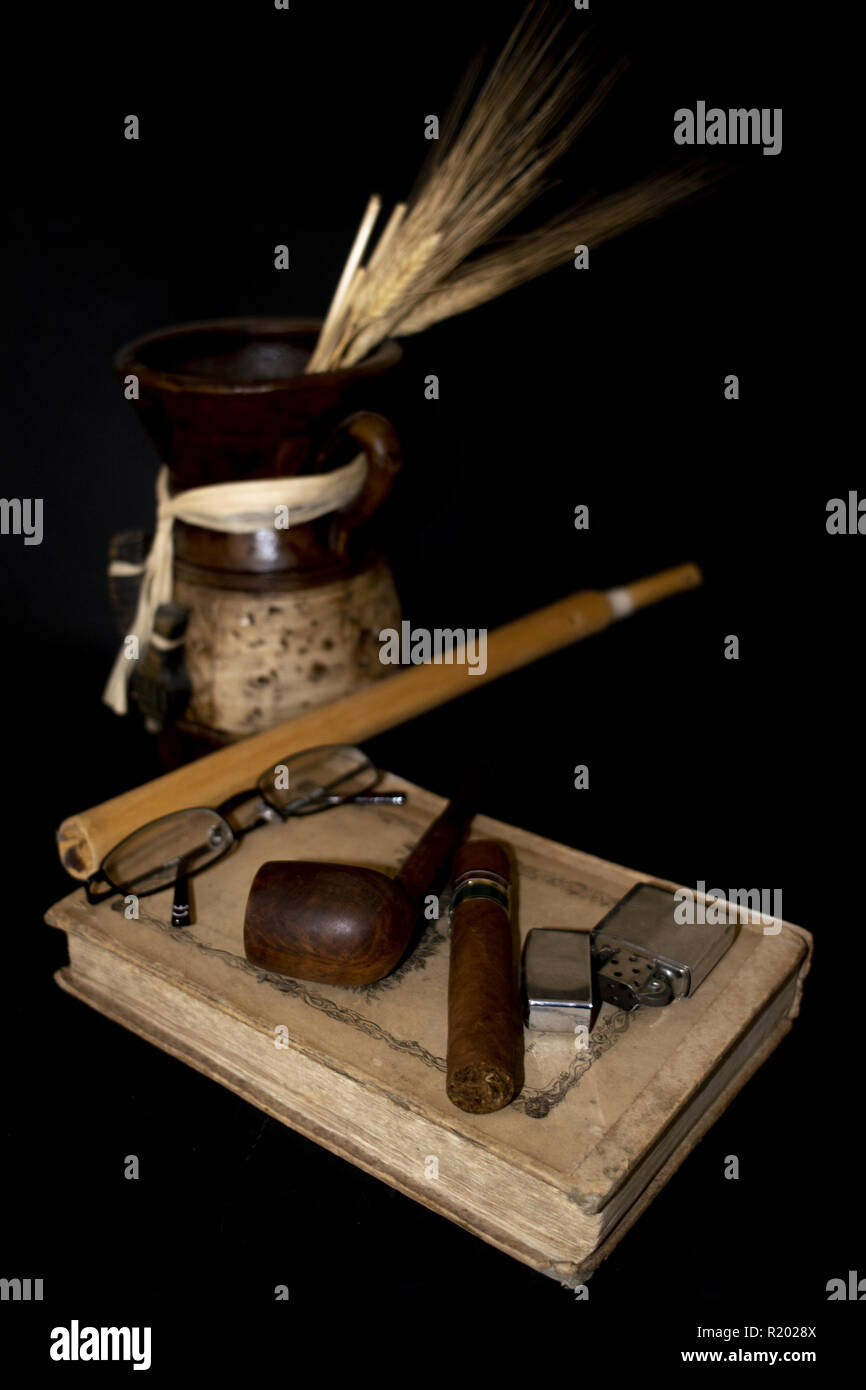 cuban cigar with metallic lighter on an old book Stock Photo - Alamy