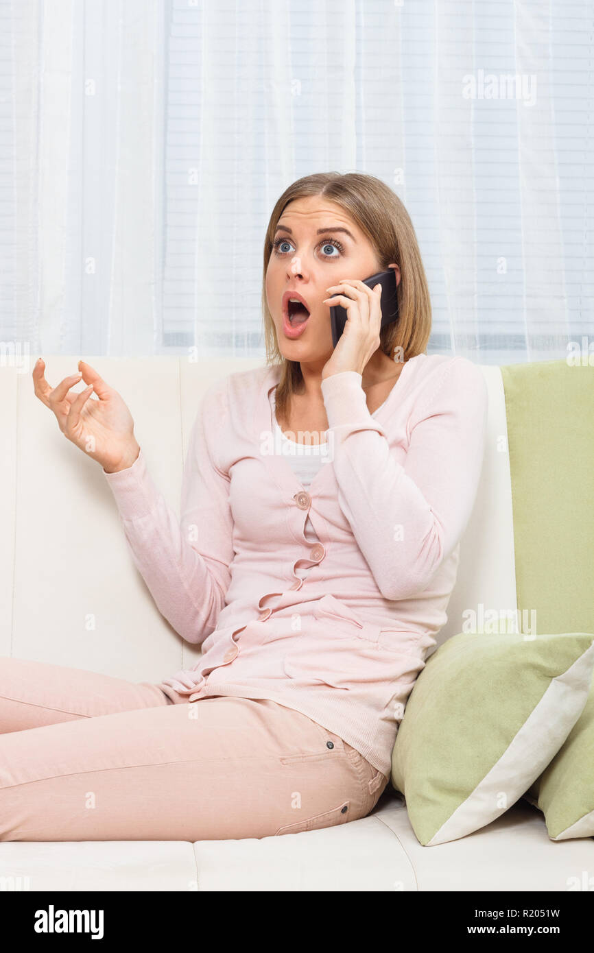 Shocked woman on the phone Stock Photo - Alamy
