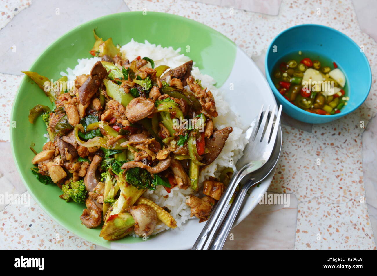 spicy stir-fried chicken innards with basil leaves on rice Stock Photo ...