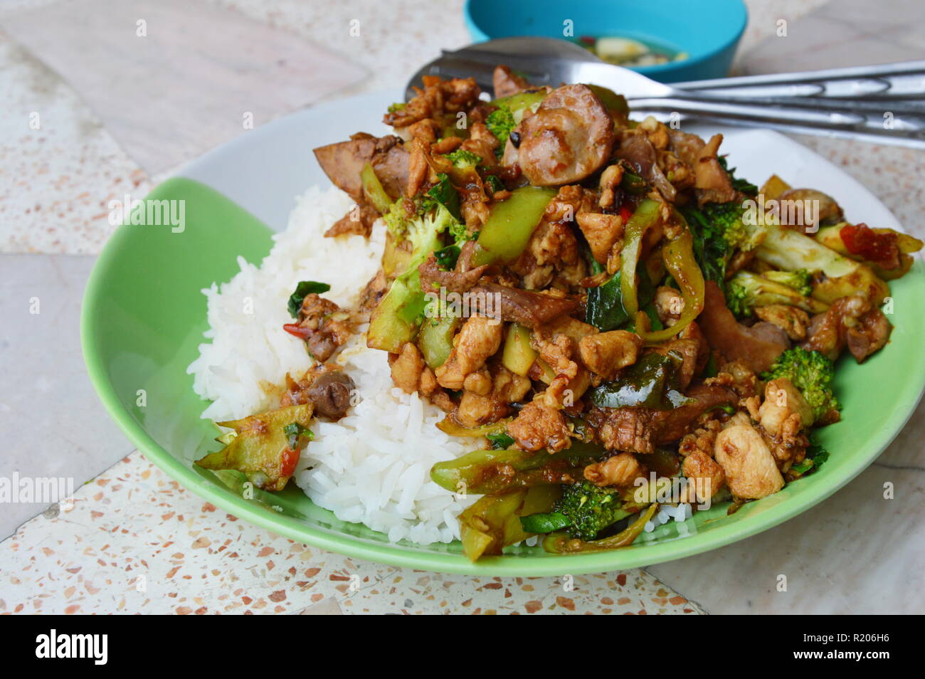 spicy stir-fried chicken innards with basil leaves on rice Stock Photo ...