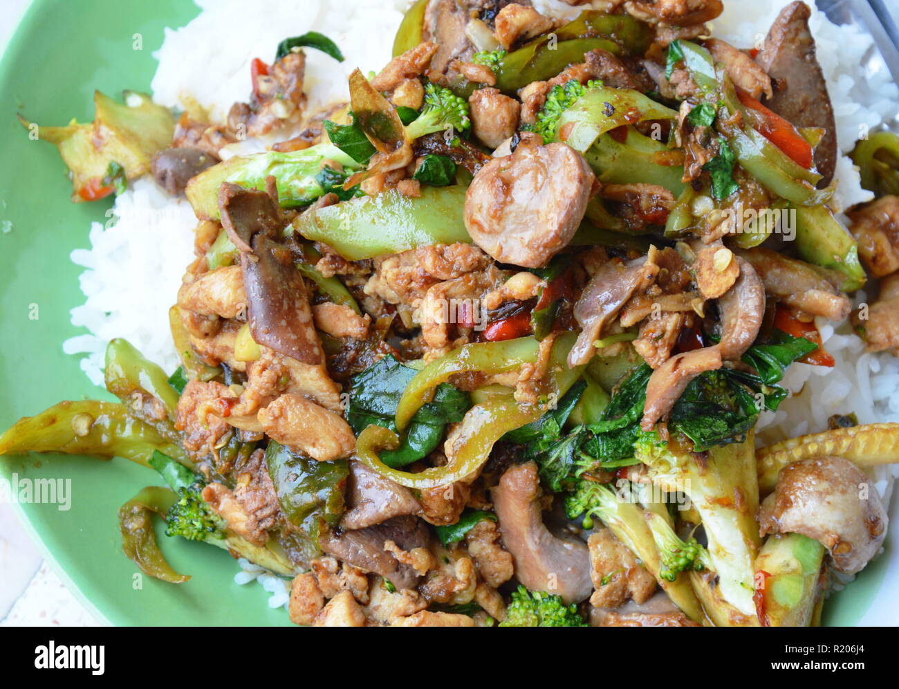 spicy stir-fried chicken innards with basil leaves on rice Stock Photo ...