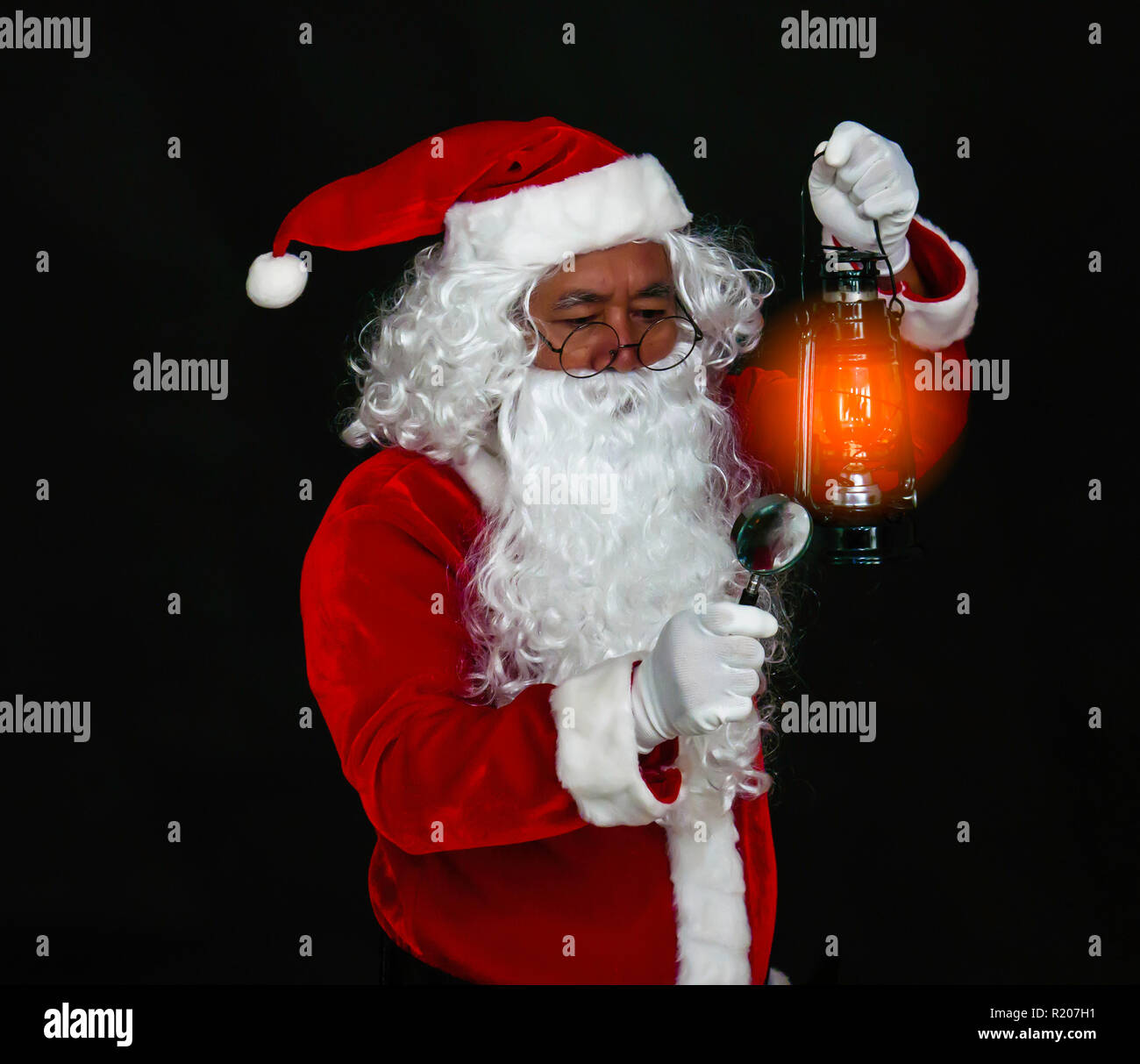 Santa Claus holding lantern for lighting studio shot on black ...