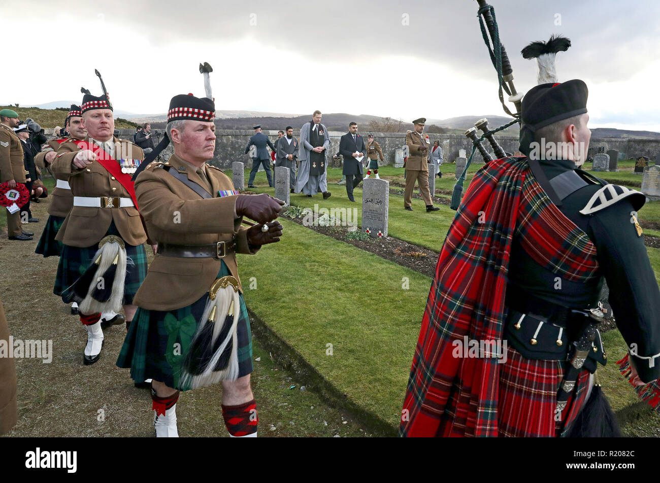 The Colour Party pass the graves of service men from Force K6 during ...