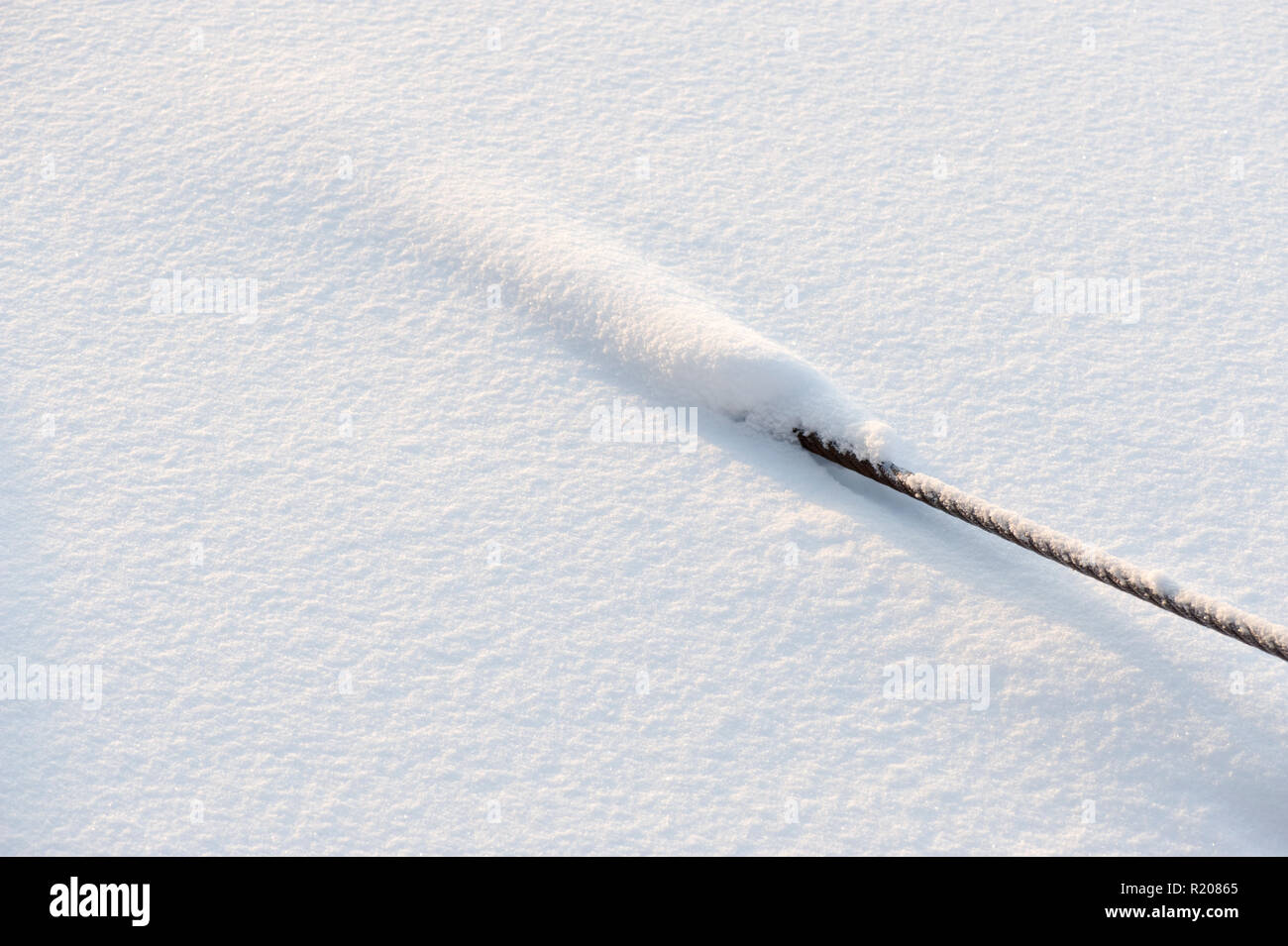 Steel cable buried in snow Stock Photo - Alamy