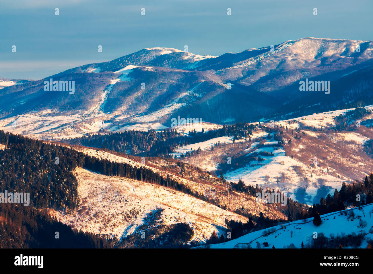 winter scenery in mountains. forested hills in snow. lovely cold ...