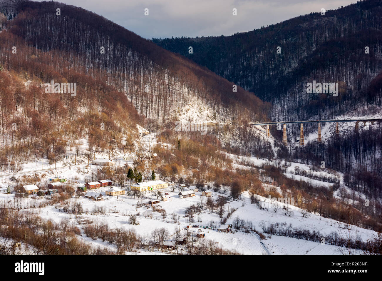 winter rail road transportation in mountains. station and village on ...