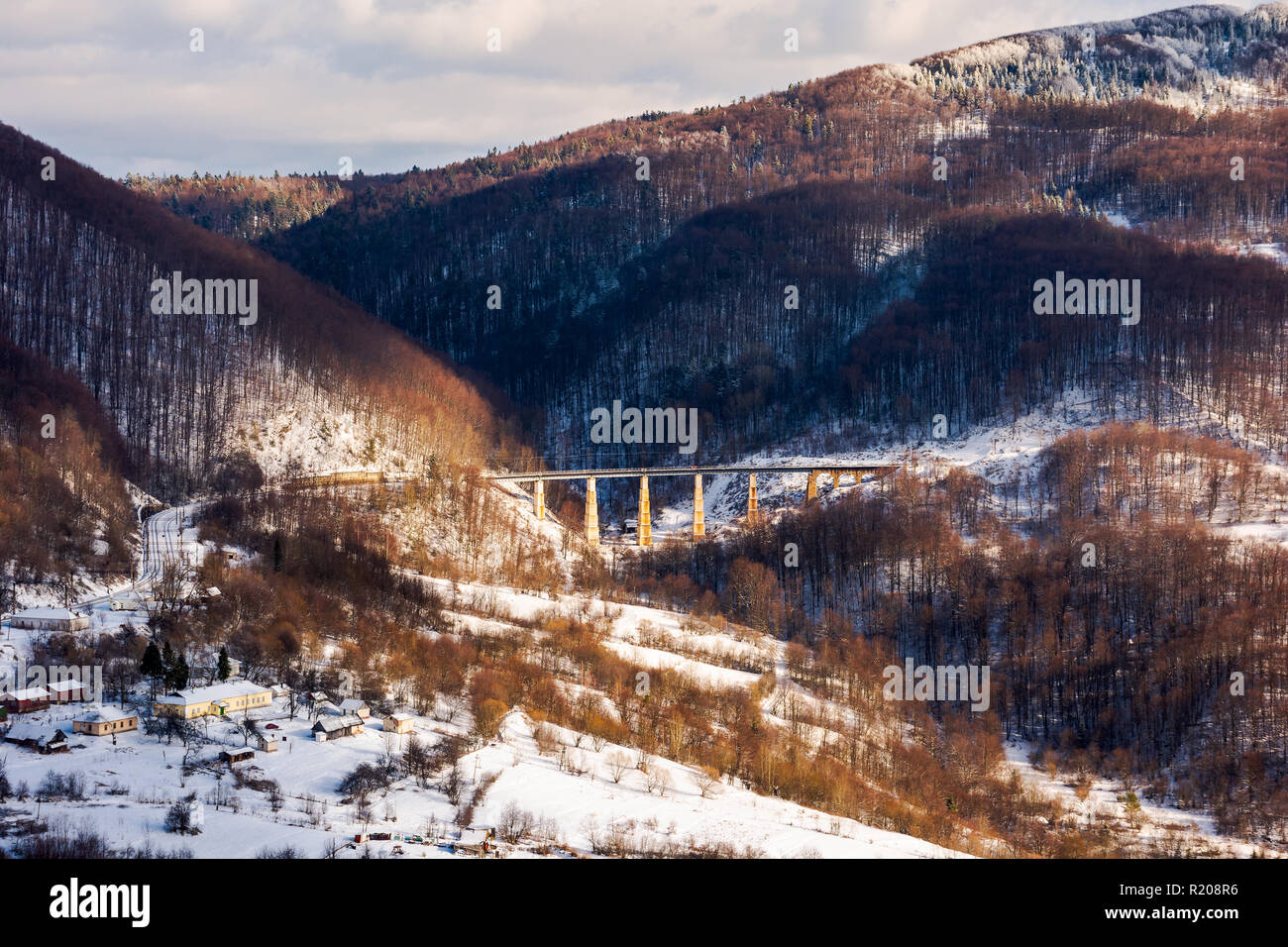 winter rail road transportation in mountains. station and village on ...