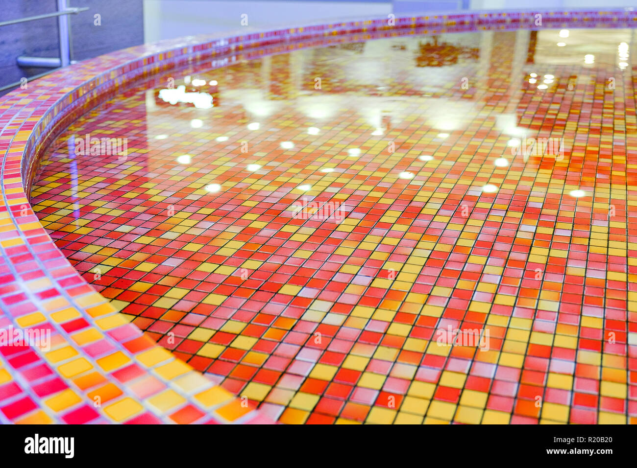 water in the pool with red-orange decorative tiles Stock Photo - Alamy