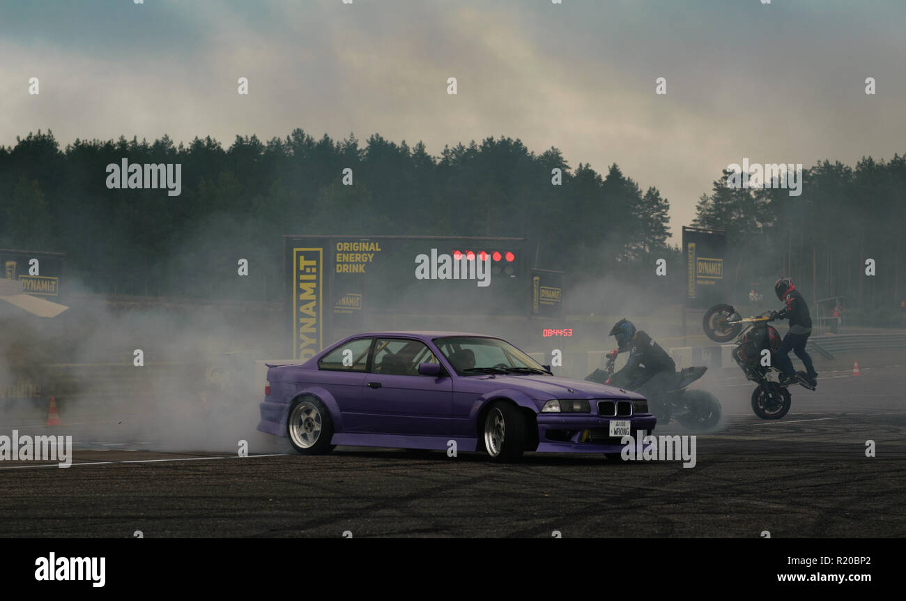 Stunt riders and drift car Stock Photo - Alamy