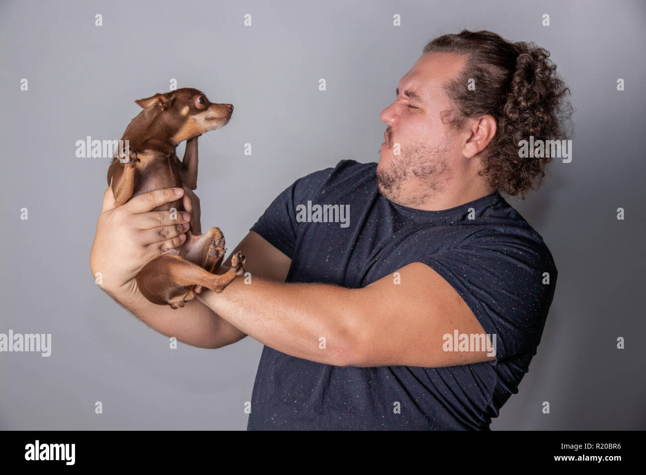 Funny fat man with little dog Stock Photo - Alamy