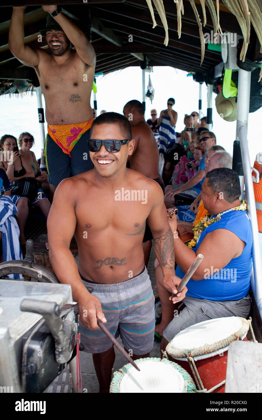 Guides performing aboard a glass bottom boat tour in Muri Lagoon ...