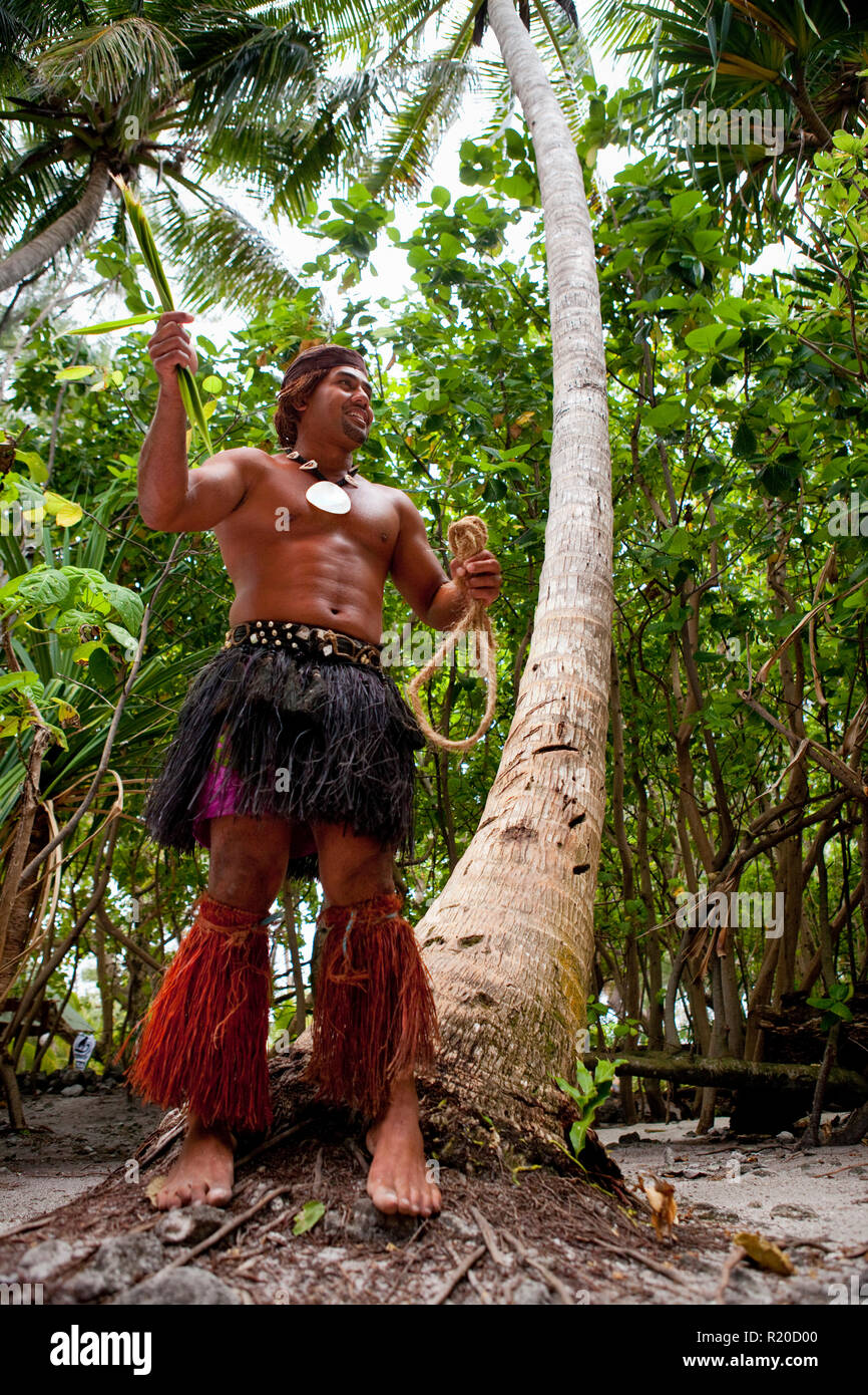 Coconut tree climbing demonstration near Muri Lagoon, Rarotonga, Cook ...