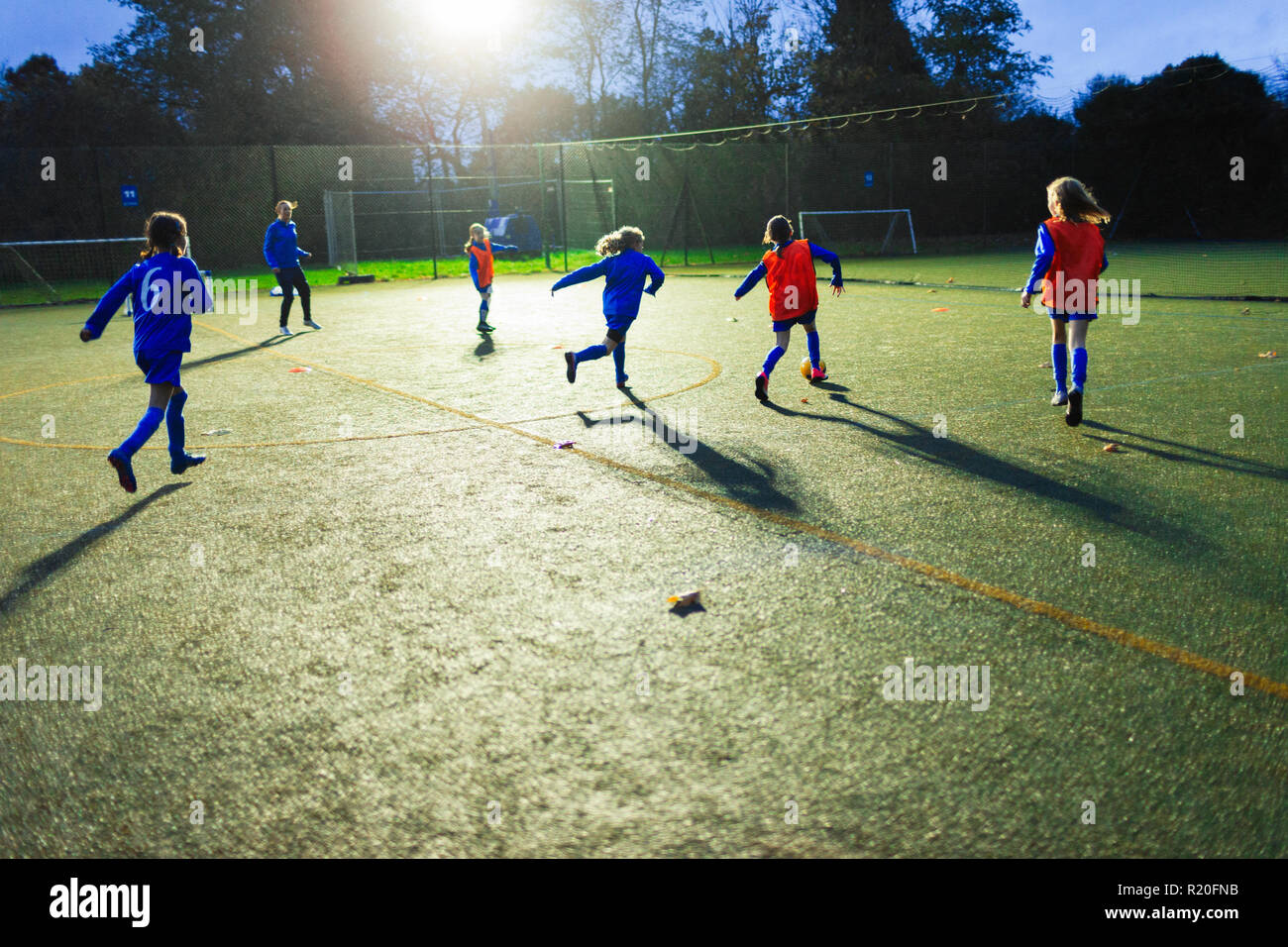 Girls soccer team practicing on field at night Stock Photo - Alamy