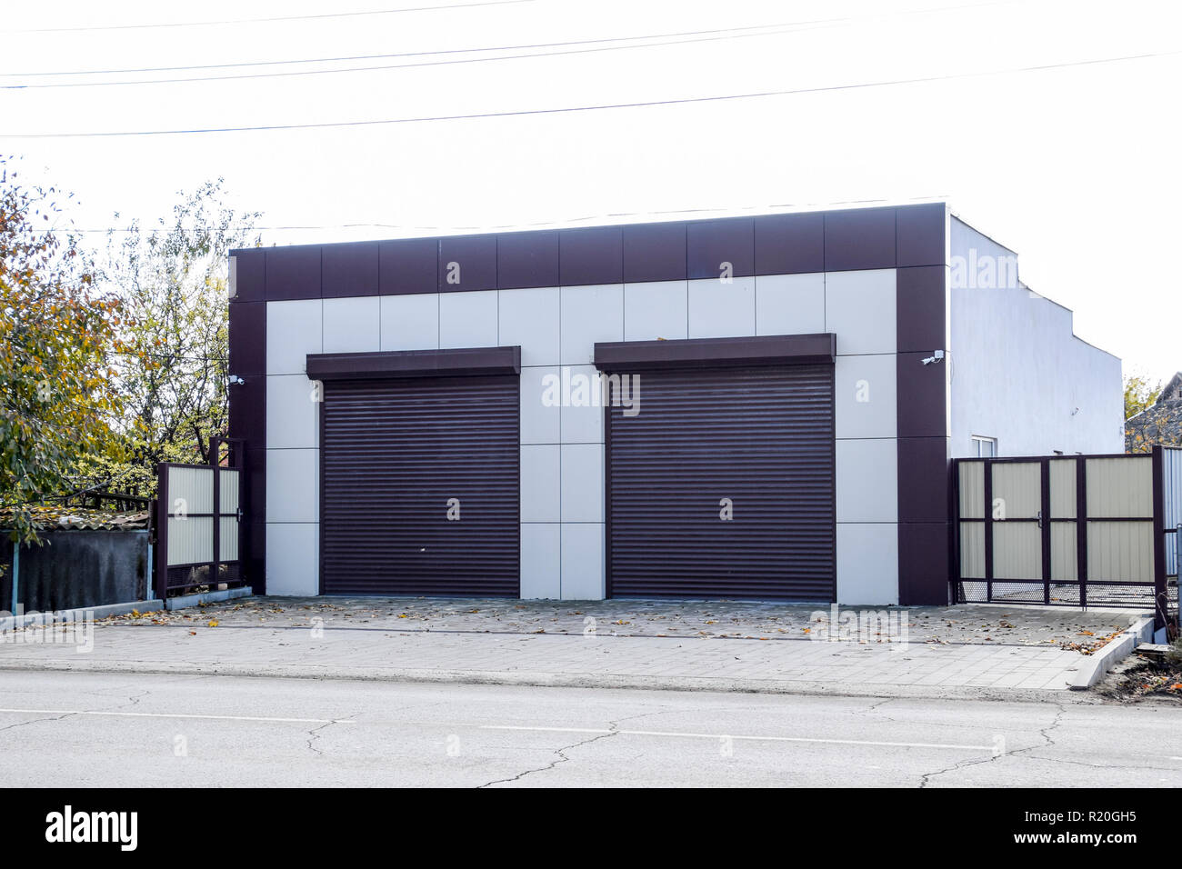 Garage for two cars with roller shutter. Modern gate in the garage with ...