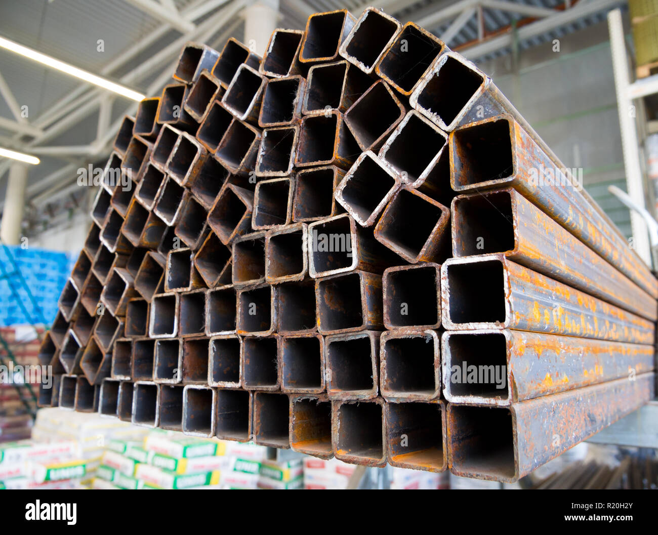 Pile of steel profile pipe on a warehouse rack Stock Photo - Alamy