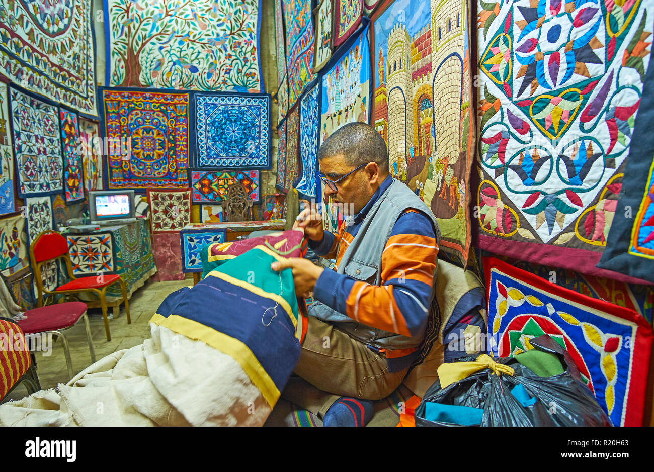 CAIRO, EGYPT - DECEMBER 21, 2017: The artisan makes the applique of the ...