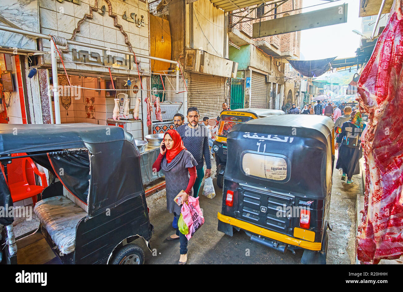 CAIRO, EGYPT - DECEMBER 21, 2017: Tuk-tuks ride along the butchers ...
