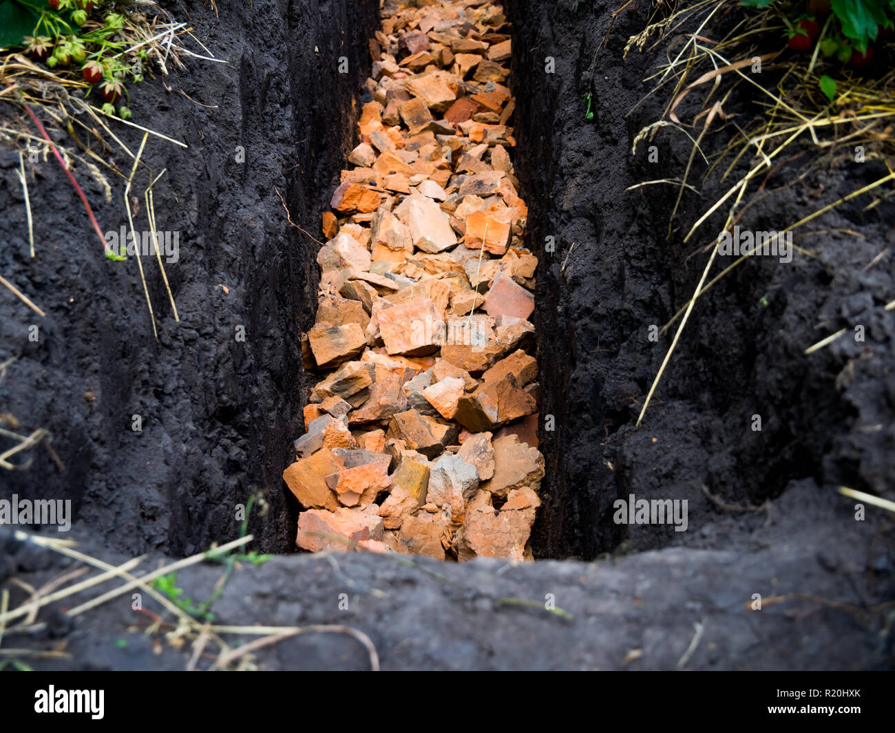 Trench on the garden plot with the remains of broken brick Stock Photo ...