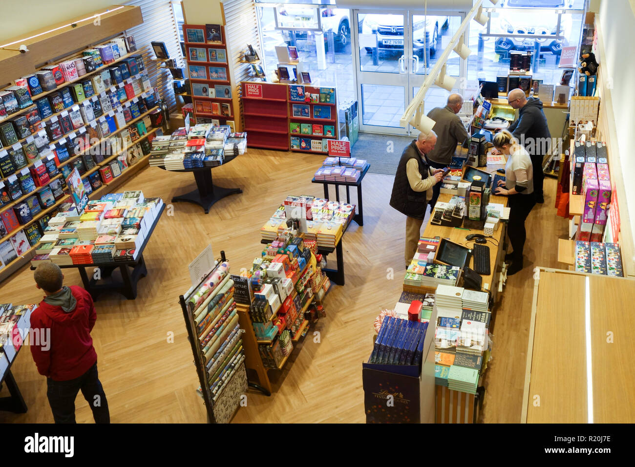 Customers and staff at counter in bookshop in shopping mall Stock Photo ...