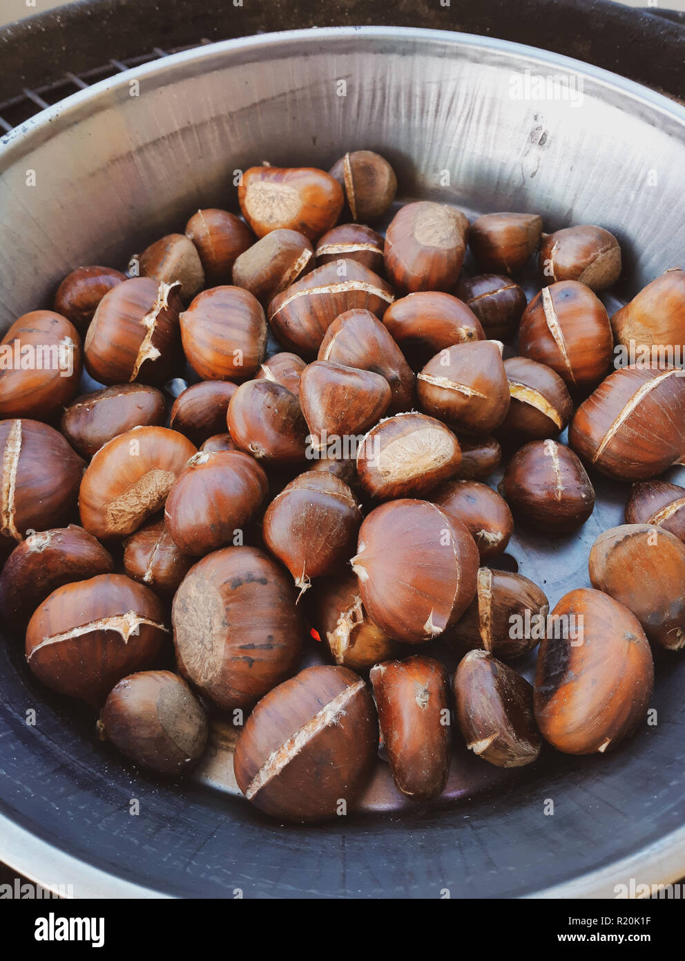 Roasted chestnuts in an iron pan cooked on the grill Stock Photo - Alamy