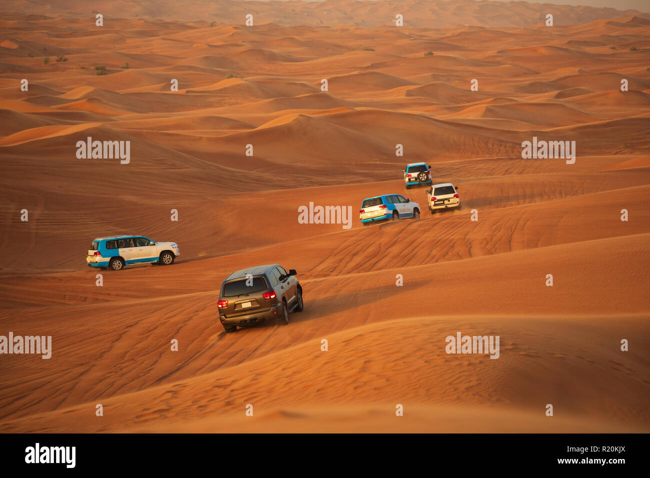 Off-road adventure with SUVs driving in Arabian Desert at sunset ...