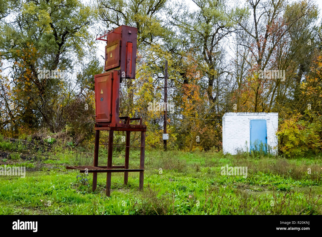 Old rusty electric transformer in the park. Electric transformer box ...