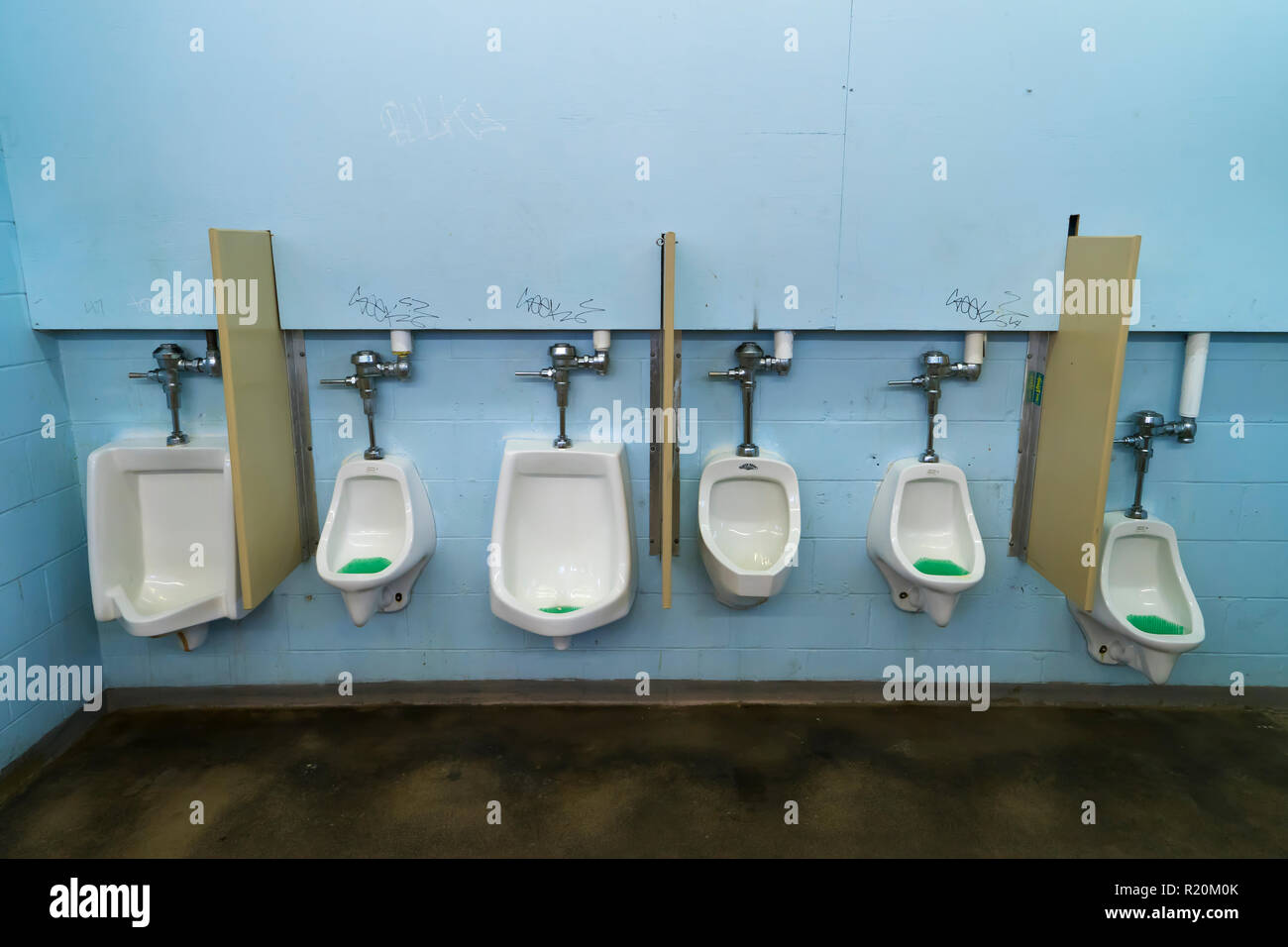 Urinals of various sizes in a public restroom Stock Photo - Alamy
