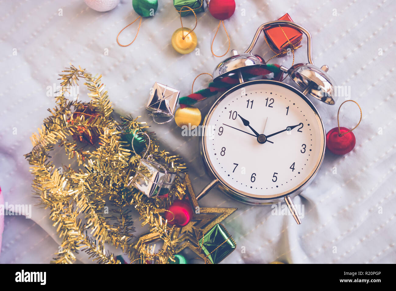 vintage alarm clock, gift boxes on bed Stock Photo - Alamy